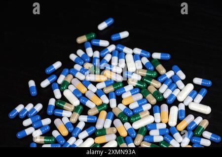 Blue white pills, variation of scattered medication in capsules ...