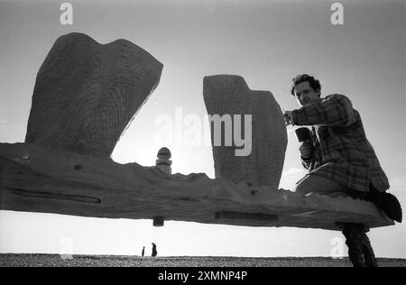 Artist Steve Geliot completing an elm and cast iron bench as part of a ...