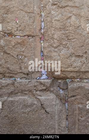 Paper notes with blessings and prayers inside Western Wall cracks. The ...