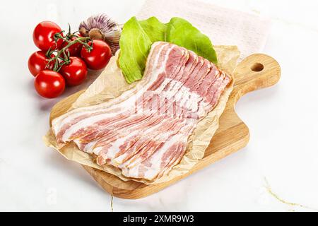 Sliced raw pork bacon oved board Stock Photo - Alamy