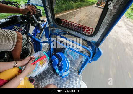 School students riding a tricycle in Sorsogon province in the ...