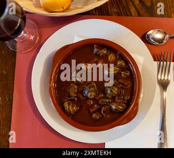 Plate of Caracoles cooked in shells on grill aioli sauce Stock Photo ...