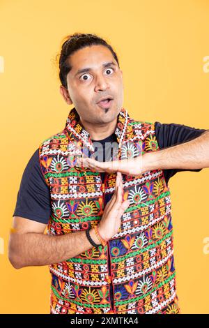 Serious man requesting timeout, doing hand gestures, unable to continue ...