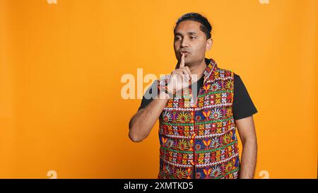 Annoyed indian man doing shushing hand gesturing, irritated by noise ...