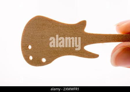 Mini wooden guitar model in hand on a white background Stock Photo - Alamy