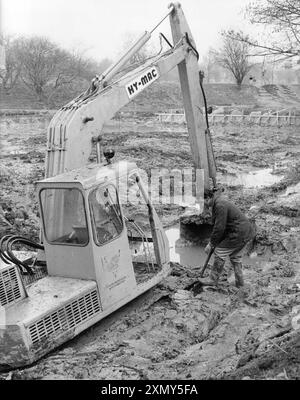 Mechanical digger stuck in mud Stock Photo - Alamy