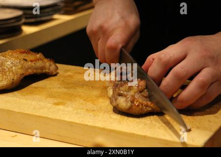Cooking scene of Japanese cuisine (charcoal grilled chicken) in Kyoto ...