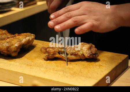 Cooking scene of Japanese cuisine (charcoal grilled chicken) in Kyoto ...