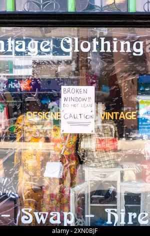 Broken shop window covered by polythene safety film and sign Stock ...