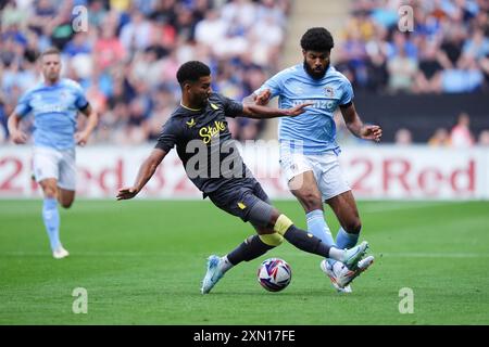 Coventry City's Ellis Simms (right) tries to win the ball ahead of ...