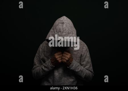 male thief hooded head hacking technology security light background ...