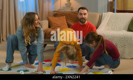 Kids with father playing twister game at home. Family activity Stock ...