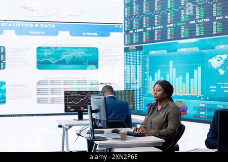 Chief executive officer reviews data shown on big display in the office ...