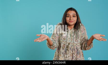 Indian woman shrugging shoulders, unable to provide answer, having ...