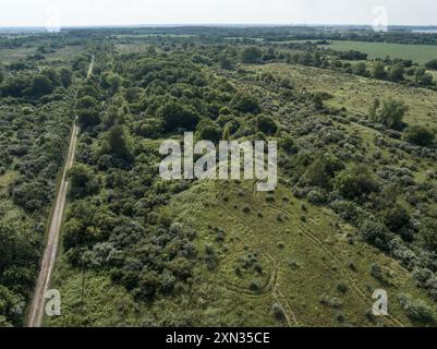 A road runs past WWII-era ammunition bunkers at Midewin National ...