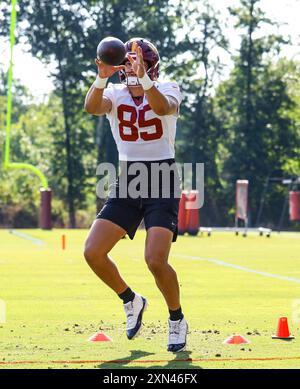 Washington Commanders tight end Cole Turner (85) having a conversation ...