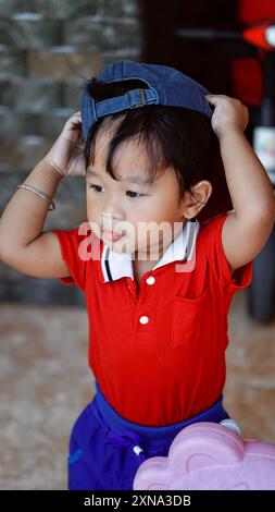 little boy wearing a backwards hat, cute behavior of children exploring ...