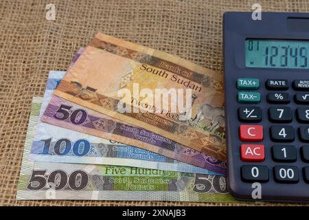 South Sudan currency notes of 500, 100, 50 and 25 with a calculator ...