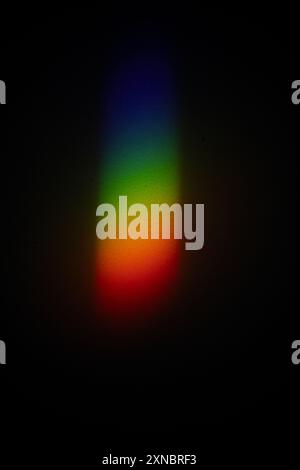 Prism rainbow Colours refracted onto ceiling in photographers home. red ...