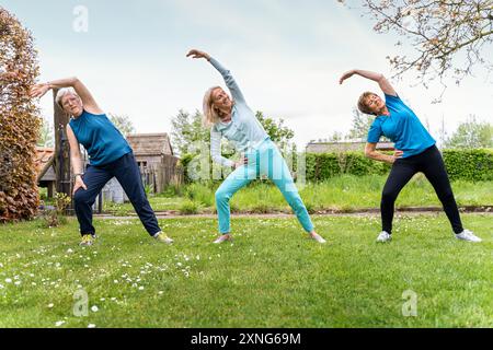 A group of elderly women use outdoor fitness facilities in Wenfeng Park ...