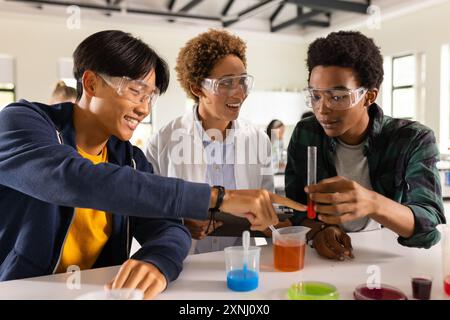 In high school, teenagers conducting science experiments in classroom ...