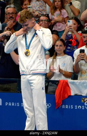 Leon Marchand (France) receives the gold medal during Swimming - Men's ...