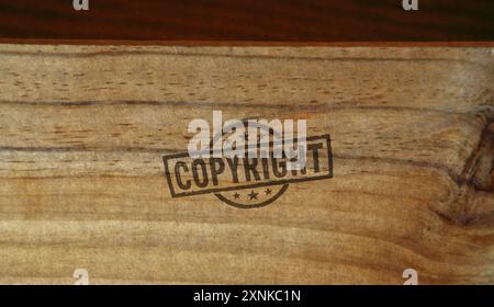 Copyright stamp printed on wooden box. Trademark intellectual property ...