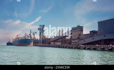 Moored cargo ships and harbor cranes in port. Seaport, cargo container ...