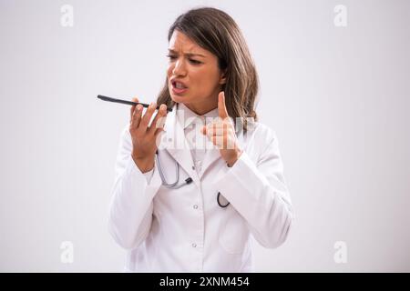 Portrait of angry doctor who is talking on phone with patient Stock ...