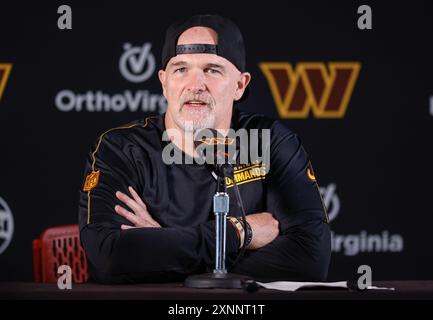 Washington Commanders head coach Dan Quinn speaks before an NFL ...