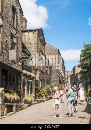 People walking along Howarth Main Street, Yorkshire, England, UK Stock ...