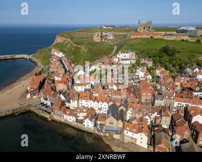 Aerial view over Whitby Old Town buildings with the abbey on the hill ...