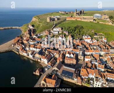 Aerial view over Whitby Old Town buildings with the abbey on the hill ...