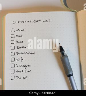 A photograph of a bullet journal notebook, with a Christmas gift list ...