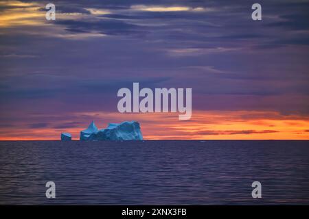Iceberg against orange sunset sky, Antarctica, Polar Regions Copyright ...