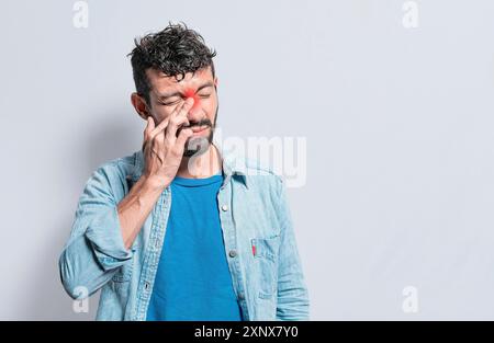 A person with nasal bridge pain. Man with nasal bridge headache, person ...