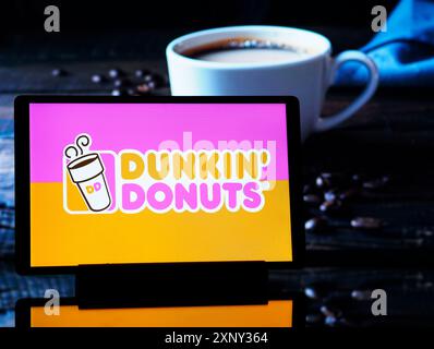 In this photo illustration, a Dunkin Donuts (Dunkin Brands Inc.) logo ...