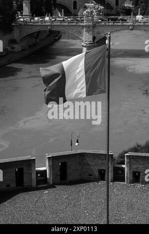 The Tibre river behind the Italian Flag blowing in wind viewed from ...