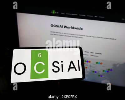 Person holding smartphone with logo of Luxembourgish company OCSiAl on ...