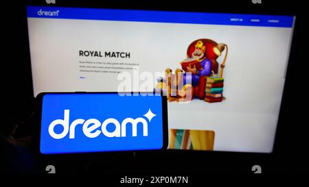 Person holding monbile phone with logo of Japanese company Tokyo Steel ...