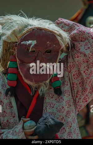 Portrait of a monk wearing a mask with white hair and standing at a ...