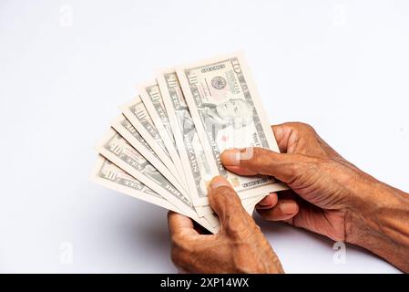 Counting US paper currency 10 dollar against white background Stock ...