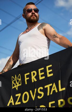 Ukrainian activist posing with a sign Free Azov outdoors. Kyiv - 15 ...