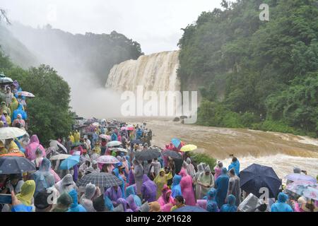 Tourists visit the Huangguoshu Waterfall scenic area in Guiyang City ...