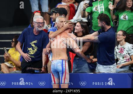 France's Damien Joly embraces with family members after the Men's 1500m ...