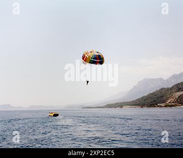 Aerial view of a parasailing adventure over the deep blue ocean with a ...