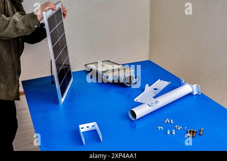 Solar panel and LED light are prepared for installation on mounting ...