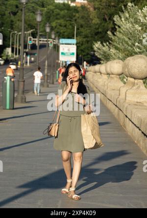 Young brunette woman wearing call center agent headset working late at ...