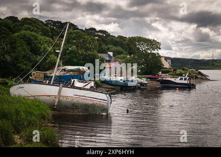 A gloomy summer HDR image of a small boatyard, with eight boats, in ...