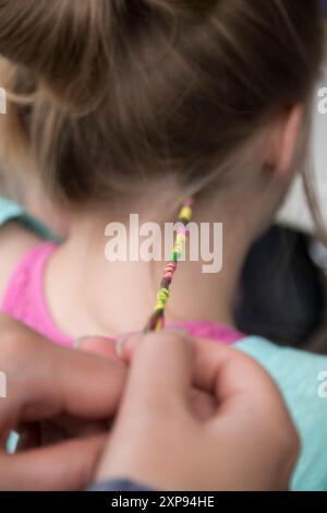 Hair braiding. Decorative ornament and colorful string braided in Stock ...